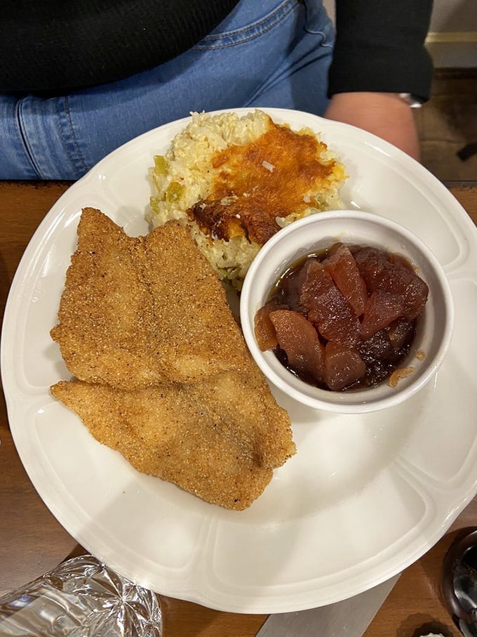 Cornmeal-crusted catfish alongside cheesy casserole and candied apples. In Tennessee, this isn't just lunch—it's edible heritage on a plate.