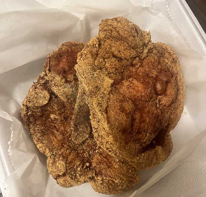 Cornmeal-crusted fried chicken that makes you question every other version you've ever had—crispy, seasoned perfection protecting juicy meat within.