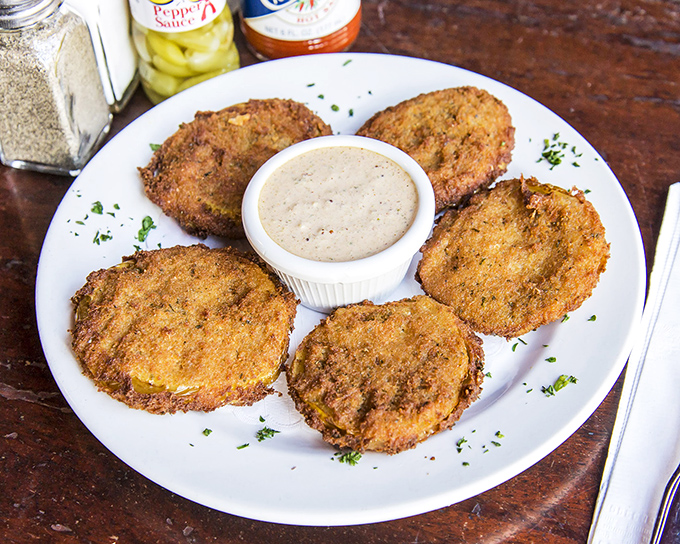 Golden-fried green tomatoes with a crispy coating that shatters just right, served with a dipping sauce worth bottling and taking home.