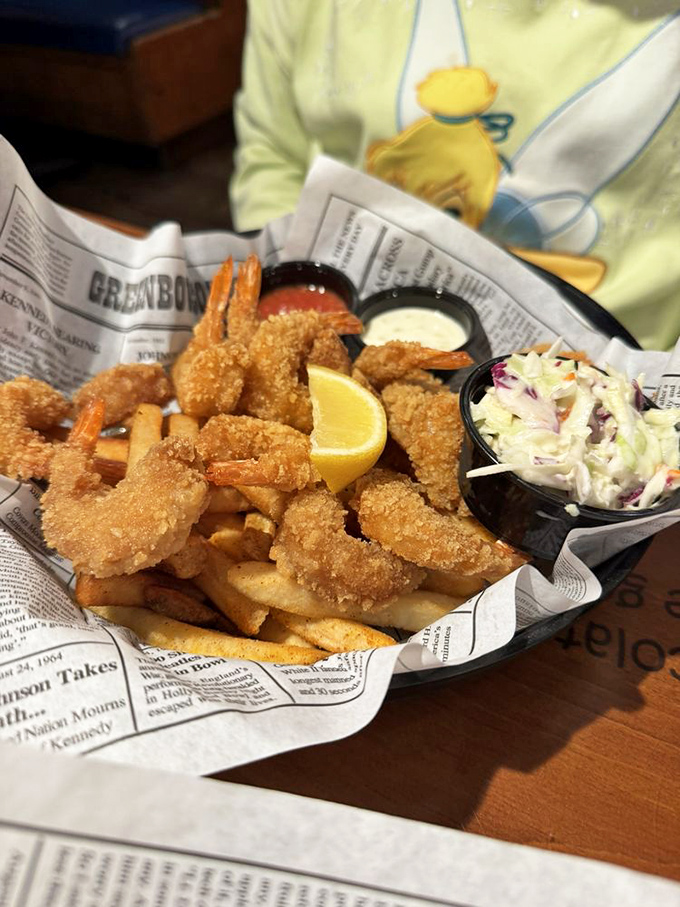 Newspaper-lined baskets of golden-fried shrimp—crispy on the outside, tender within—served with the kind of fries that disappear one "just one more" at a time.