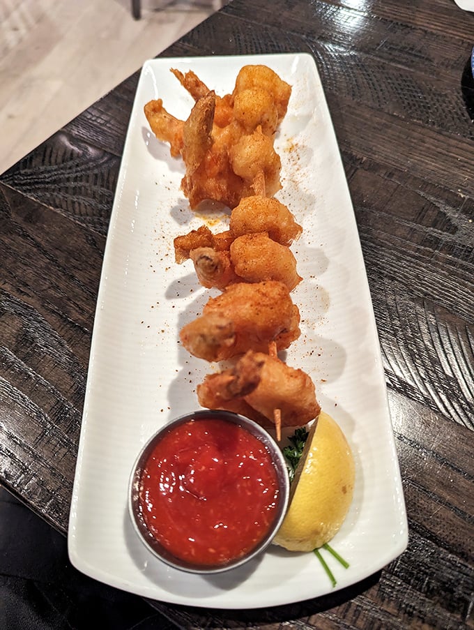 These golden-fried shrimp aren't just appetizers—they're the opening act for a seafood concert. Crispy, plump, and ready for their cocktail sauce companion.