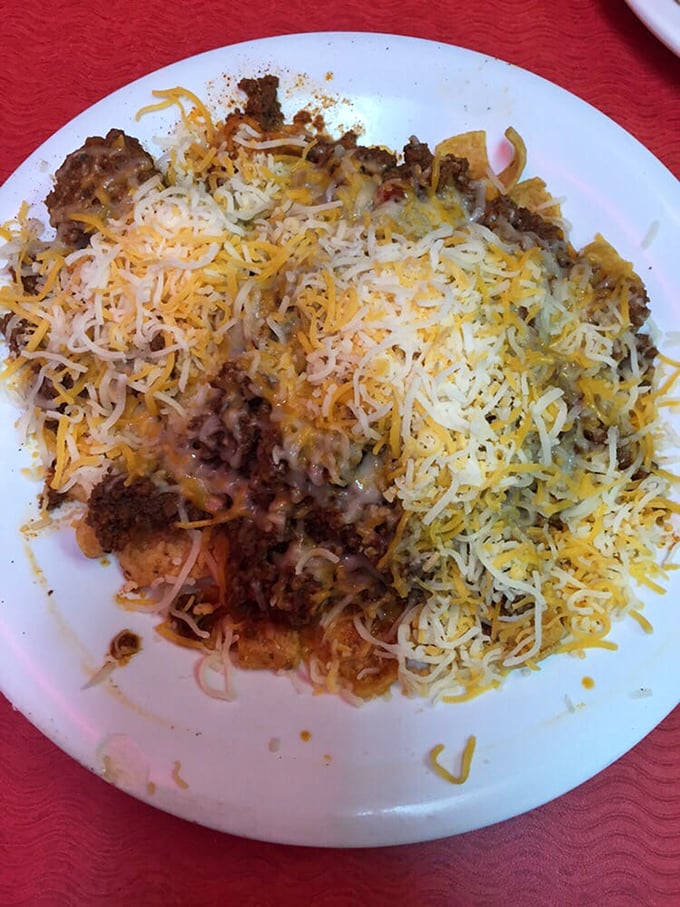 A mountain of melted cheese blankets what lies beneath—a hearty mixture that promises to cure whatever ails you.