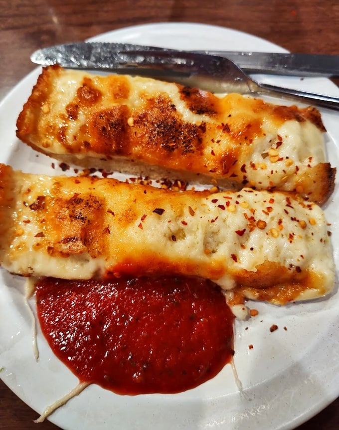 Garlic bread that doesn't whisper its presence—it announces itself to your taste buds like a brass band on parade day.