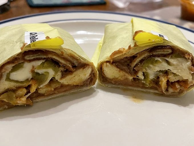 Cross-section evidence of burrito perfection: melted cheese mingles with beans and green chiles in a harmony so beautiful it deserves its own symphony.