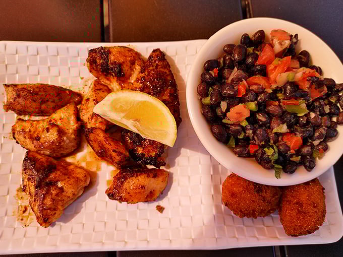 Blackened grouper cheeks with black bean salad—proof that sometimes the best parts of the fish aren't the ones everyone knows about.