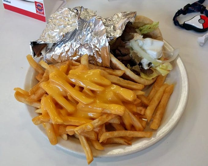 Golden fries swimming in melted cheese—the kind of guilty pleasure that makes you forget about calories and remember what joy tastes like.