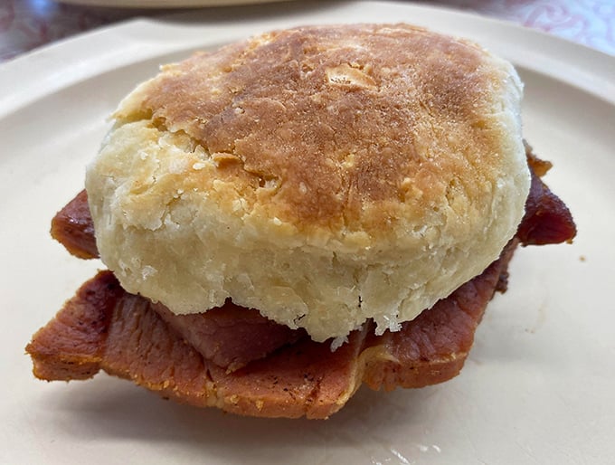 The ham biscuit—a masterpiece of simplicity where country ham meets house-made biscuit. No fancy garnishes needed when the basics are this perfect.