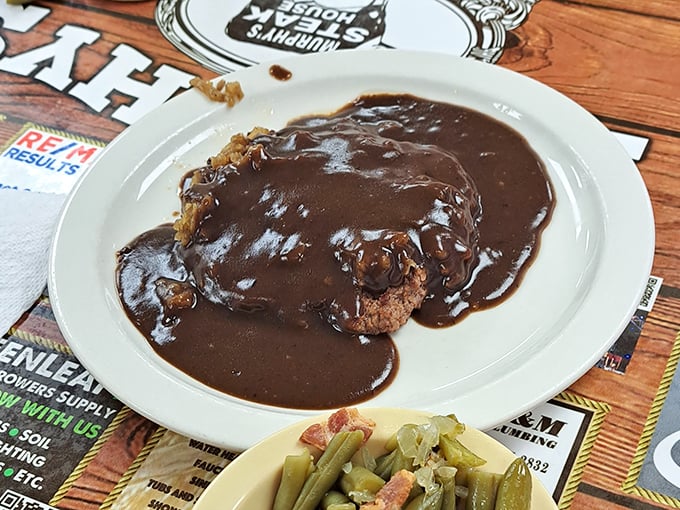 The hamburger steak doesn't just swim in gravy—it performs synchronized swimming routines in it. Those green beans on the side? They've clearly met a ham hock.