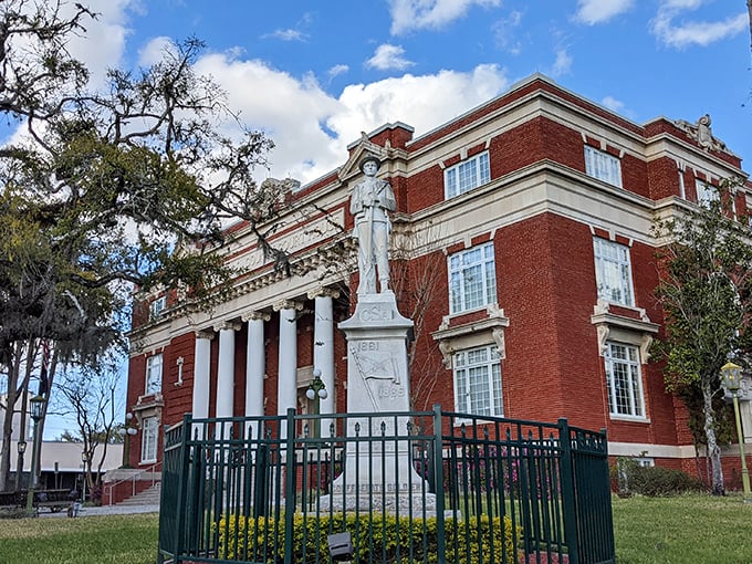The historic Hernando County Courthouse commands respect with its stately columns and red brick dignity – architecture that doesn't whisper, it announces.