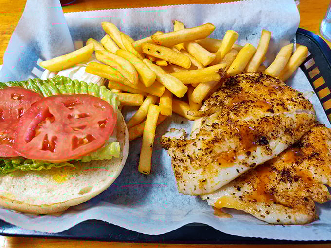 The fish sandwich that launched a thousand road trips – perfectly seasoned, expertly grilled, and served with fries that demand to be stolen one by one.