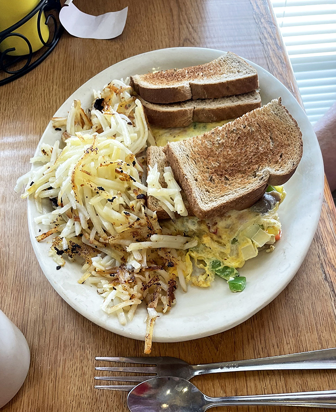 Breakfast done right – where hash browns meet eggs in that perfect morning marriage that makes you forget you're not a morning person.