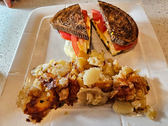 A grilled sandwich that's achieved perfect harmony with those home fries—crispy on the outside, tender within. The potato whisperer has spoken.