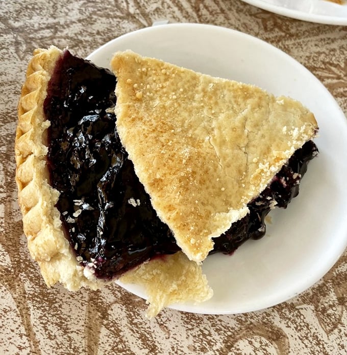 Behold the blueberry pie – with its perfectly crimped edges and bursting filling – proof that happiness can indeed be found in a nine-inch circle.
