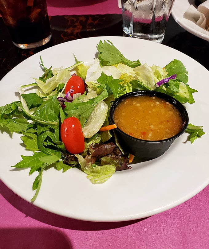 A salad that knows its role—fresh, crisp supporting actor to the meaty main attraction, with dressing that doesn't hide in the wings.