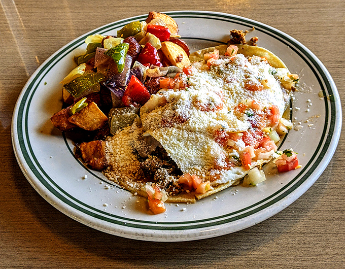 Huevos Rancheros: where breakfast meets fiesta. Those roasted potatoes on the side aren't just supporting actors—they're scene-stealers.