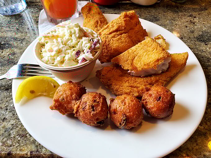 Golden hushpuppies that would make your Southern grandmother weep with joy, alongside perfectly fried fish that practically whispers "you're on vacation now."