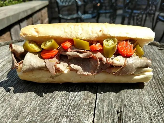 The Italian beef sandwich comes loaded with thinly sliced meat, giardiniera, and sweet peppers – Chicago's iconic handheld masterpiece ready for its close-up.