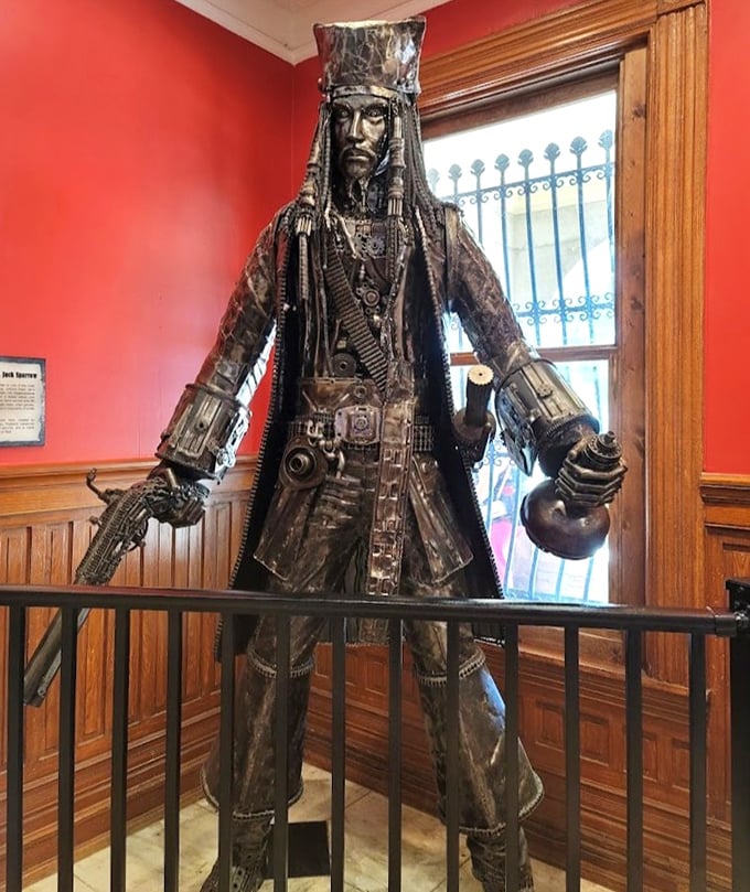 Not your average pirate. This metal sculpture stands guard like a steampunk Jack Sparrow who's been through one too many Caribbean adventures.