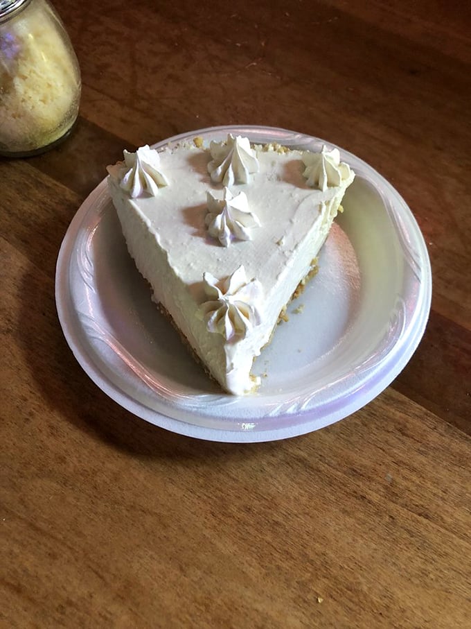 The key lime pie arrives like a celebrity—pale yellow, perfectly tart, and ready for its close-up with those adorable whipped cream dollops.