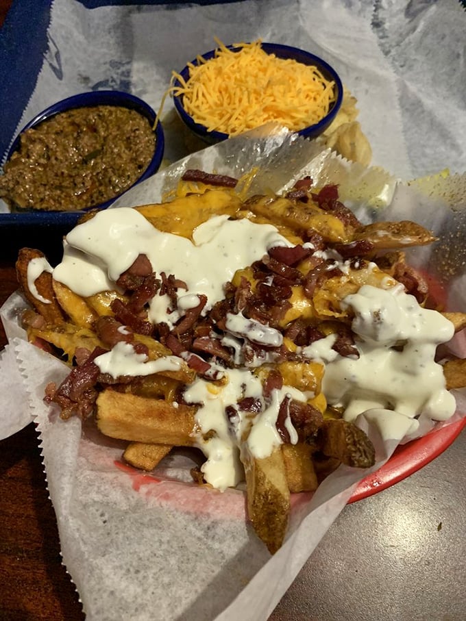 Loaded fries that require a game plan – crispy potatoes buried under an avalanche of bacon, cheese, and ranch. Fork recommended, restraint optional.