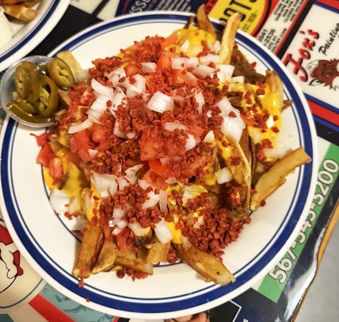 Loaded fries that don't mess around – topped with cheese, bacon bits, tomatoes and onions, they're a meal disguised as a side dish.