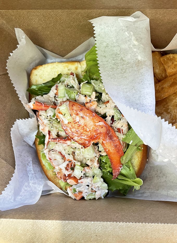 This isn't just a sandwich; it's a seafood celebration between bread. Fresh lobster salad with crisp veggies—the kind of lunch that makes Monday feel like Friday.