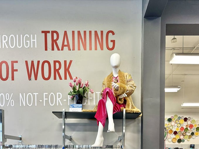 This mannequin isn't just modeling clothes—she's showcasing Goodwill's mission of dignity through work, draped in golden opportunity.
