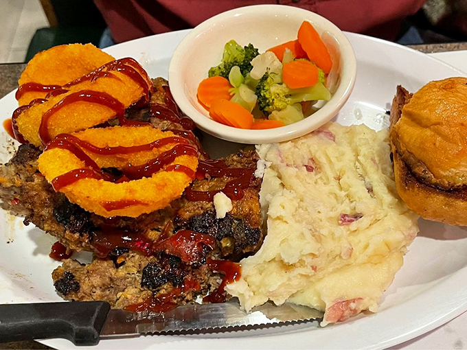 This meatloaf doesn't need a fancy introduction—it's comfort food royalty wearing an onion ring crown and barbecue sauce robes.