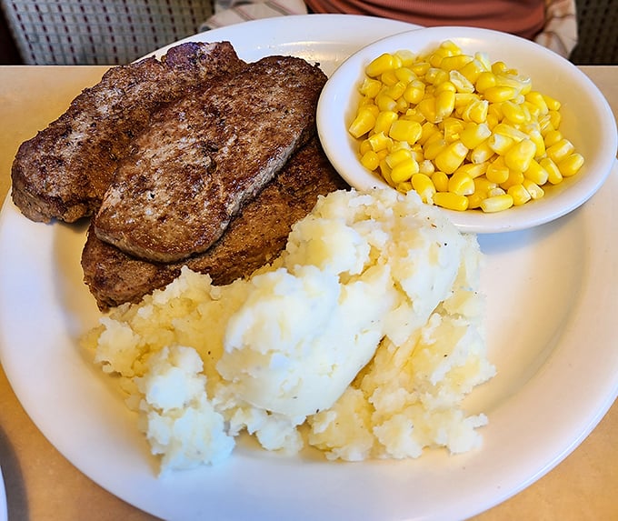 Country comfort on a plate—tender meatloaf flanked by buttery mashed potatoes and sweet corn, proving that simplicity still reigns supreme.