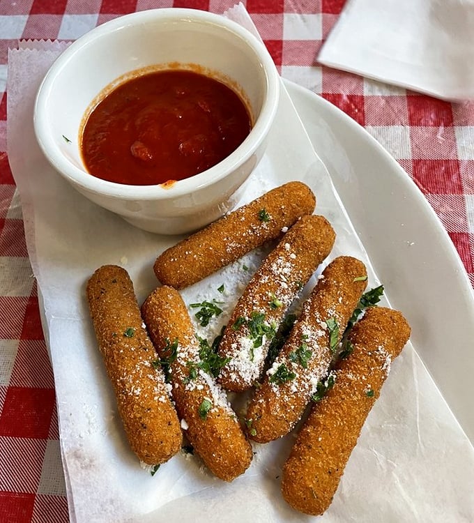 Golden-brown mozzarella sticks with that perfect pull-apart cheese stretch – the adult version of childhood joy, complete with marinara dipping sauce.