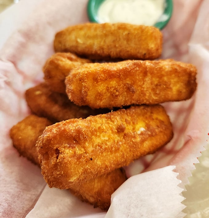 These golden mozzarella sticks aren't just appetizers – they're crispy vessels delivering molten cheese straight to your happiness receptors.