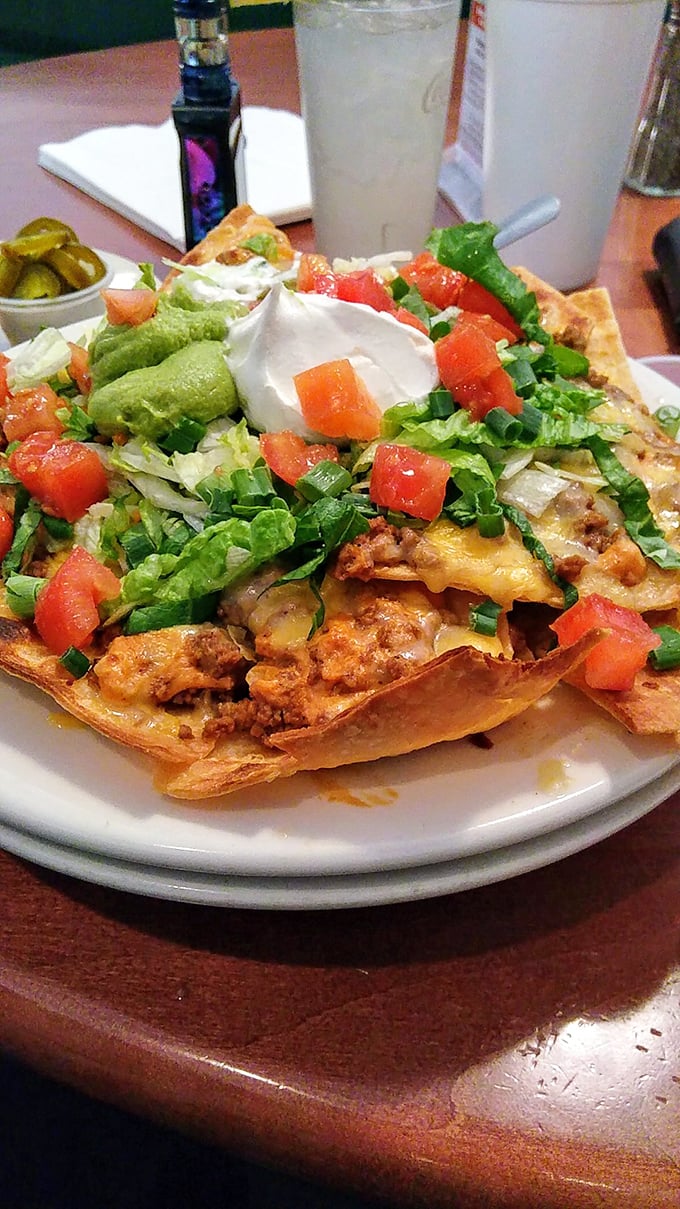 These loaded nachos aren't messing around—they're the architectural marvel of appetizers, where every layer reveals another reason to keep digging.