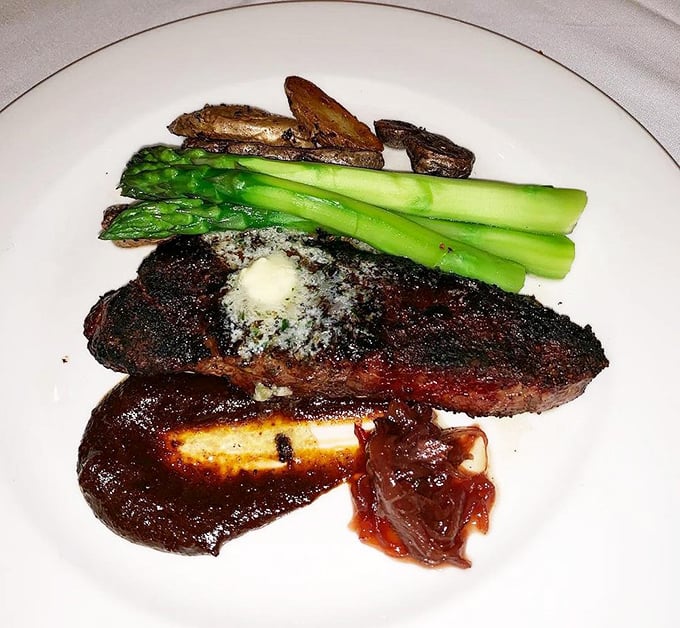 The New York Strip arrives like a rockstar on a plate – commanding attention with its perfect char, accompanied by asparagus standing at attention like loyal fans.
