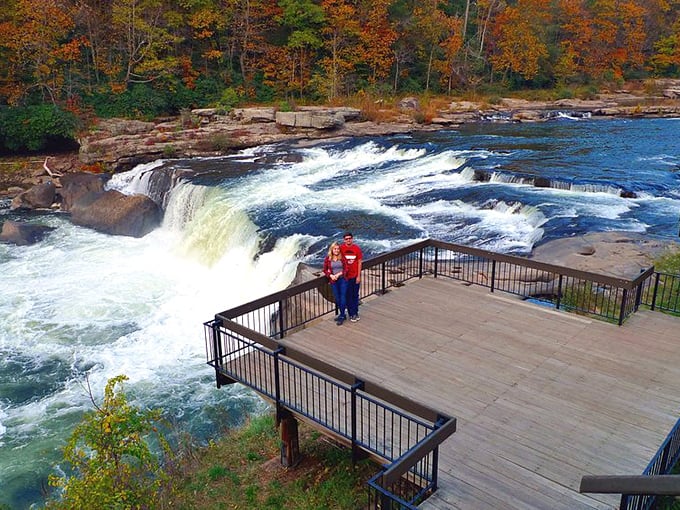 Fall foliage frames the cascading waters, creating a scene so perfect it looks like Mother Nature hired a Hollywood set designer.
