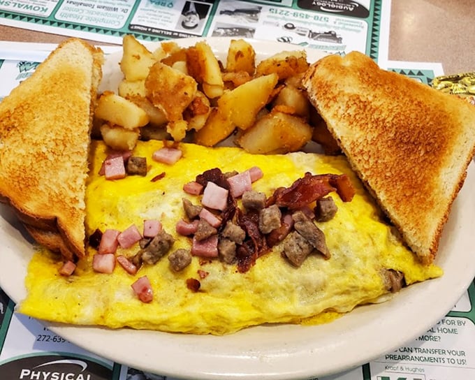 This omelet has more fillings than my last dental appointment, but infinitely more enjoyable—ham, cheese, and veggies nestled in fluffy eggs.