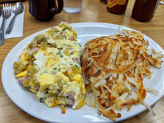 This isn't just an omelet—it's a perfectly executed egg envelope delivering ham, cheese, and veggies with the precision of a Swiss watch.