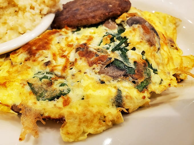 This isn't just an omelet – it's a morning masterpiece with mushrooms and spinach playing supporting roles to eggs in their finest form.