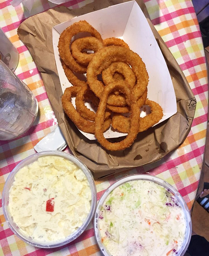 Perfectly golden onion rings that achieve the impossible: crispy coating that actually stays attached where it belongs throughout your meal.