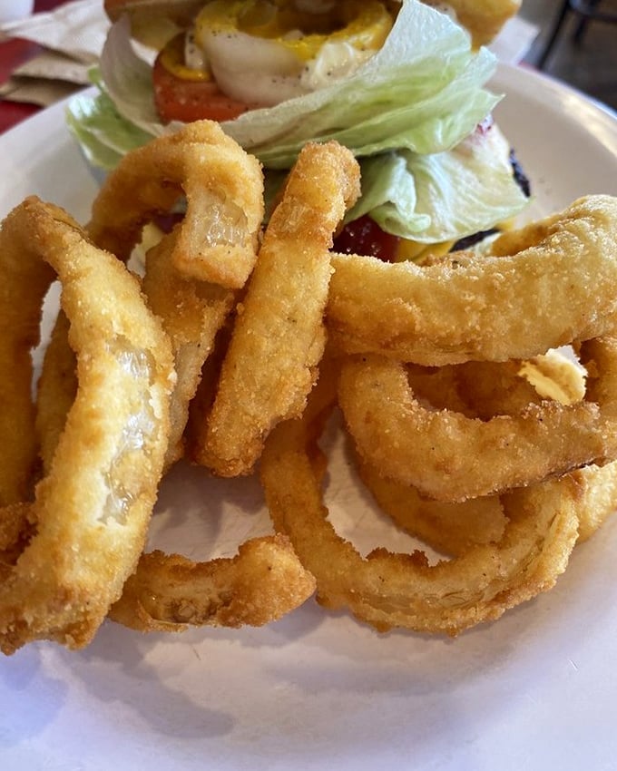 Golden-brown onion rings with that perfect crunch-to-tender ratio—the supporting actors that sometimes steal the whole show.