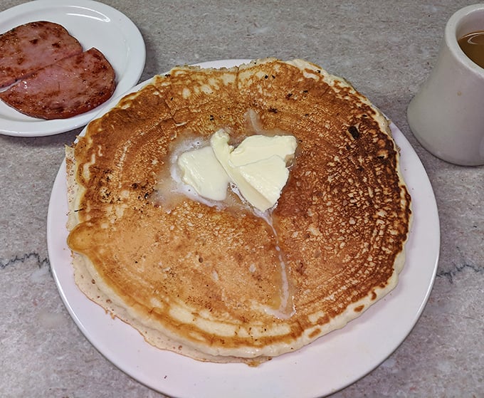 Pancakes with butter melting into golden craters—proof that simplicity, when done right, is culinary poetry.
