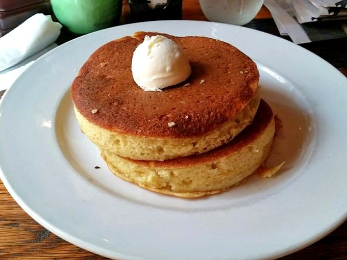 Pancakes so thick they deserve their own zip code, topped with a scoop of butter melting like a Tennessee summer day. 