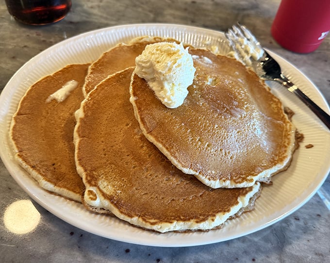 Pancakes so fluffy, they could double as pillows if they weren't so irresistibly edible.
