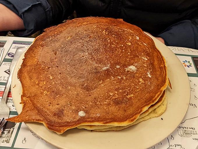 Pancakes so perfectly golden they look like they were touched by King Midas himself. The plate-covering circumference isn't excess—it's exactly what your soul ordered.