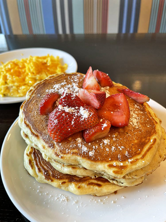 Pancake perfection that would make your grandmother jealous. Those strawberries aren't just garnish – they're trying to make this breakfast healthy.