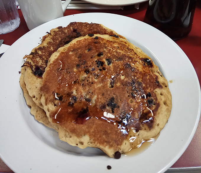 Blueberry pancakes that don't just sit on the plate—they perform, with maple syrup as their spotlight and butter as their standing ovation.