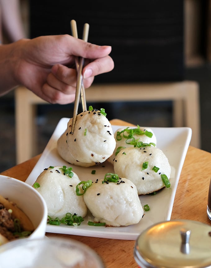 These pillowy panfried pork buns are the silent stars of Pine & Crane – plump, steamy perfection topped with scallions and sesame that'll make you forget your table manners.