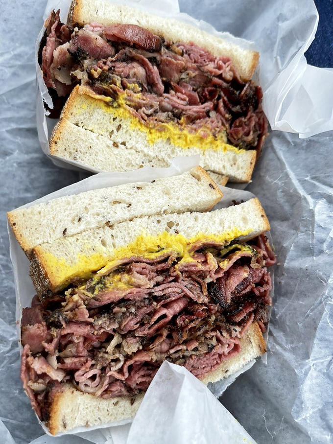 This pastrami masterpiece isn't just a sandwich; it's an engineering marvel with mustard that adds the perfect tangy counterpoint.