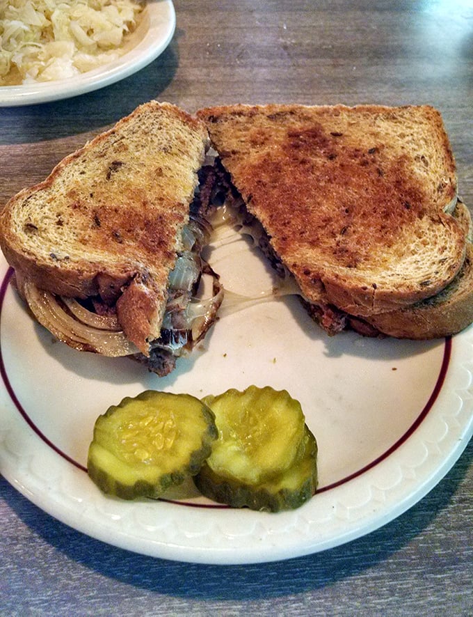 The patty melt: where bread meets beef meets cheese in a holy trinity of diner perfection. Those pickle chips aren't just garnish—they're essential tang.