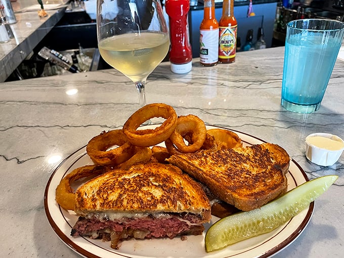 The patty melt—that perfect marriage of beef, bread, and cheese—served with onion rings that could double as delicious golden halos. Diet plans, consider yourselves postponed.