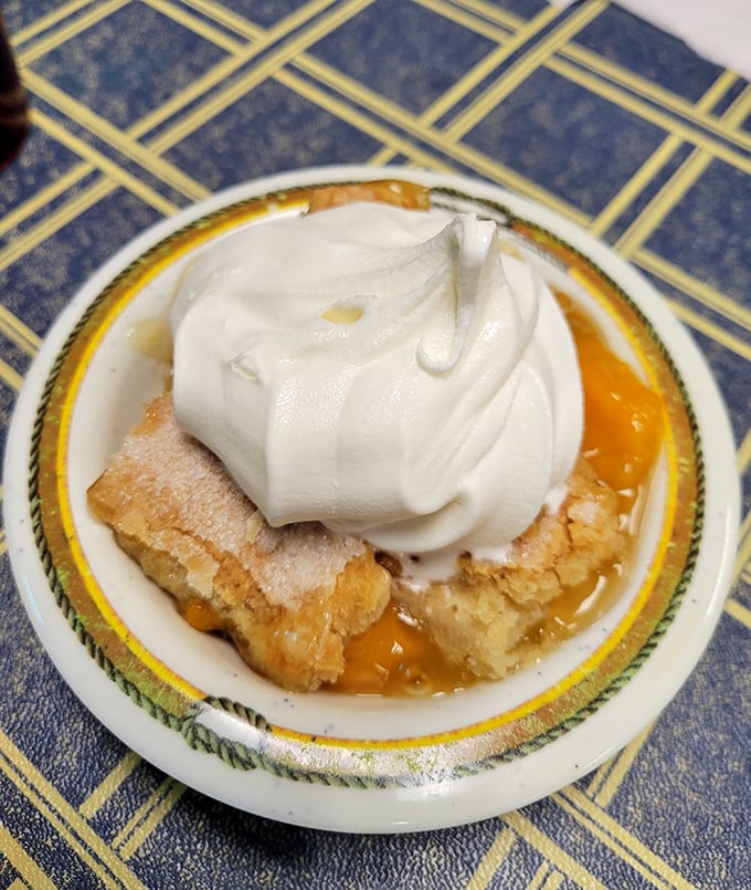 Peach cobbler that would make your grandmother both jealous and proud. That whipped cream crown is just showing off.